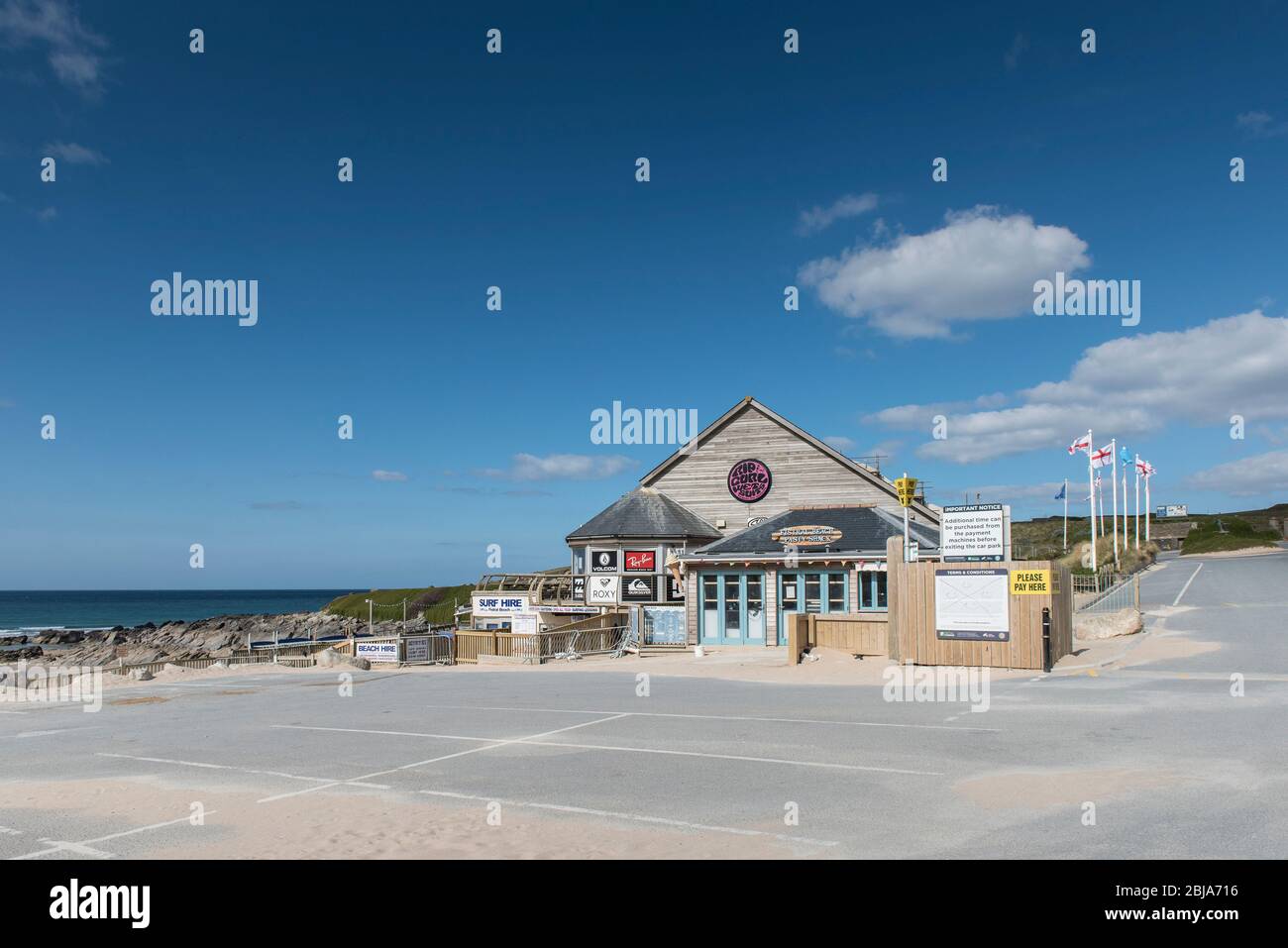 A deserted car park and closed restaurants and surf hire shops at ...