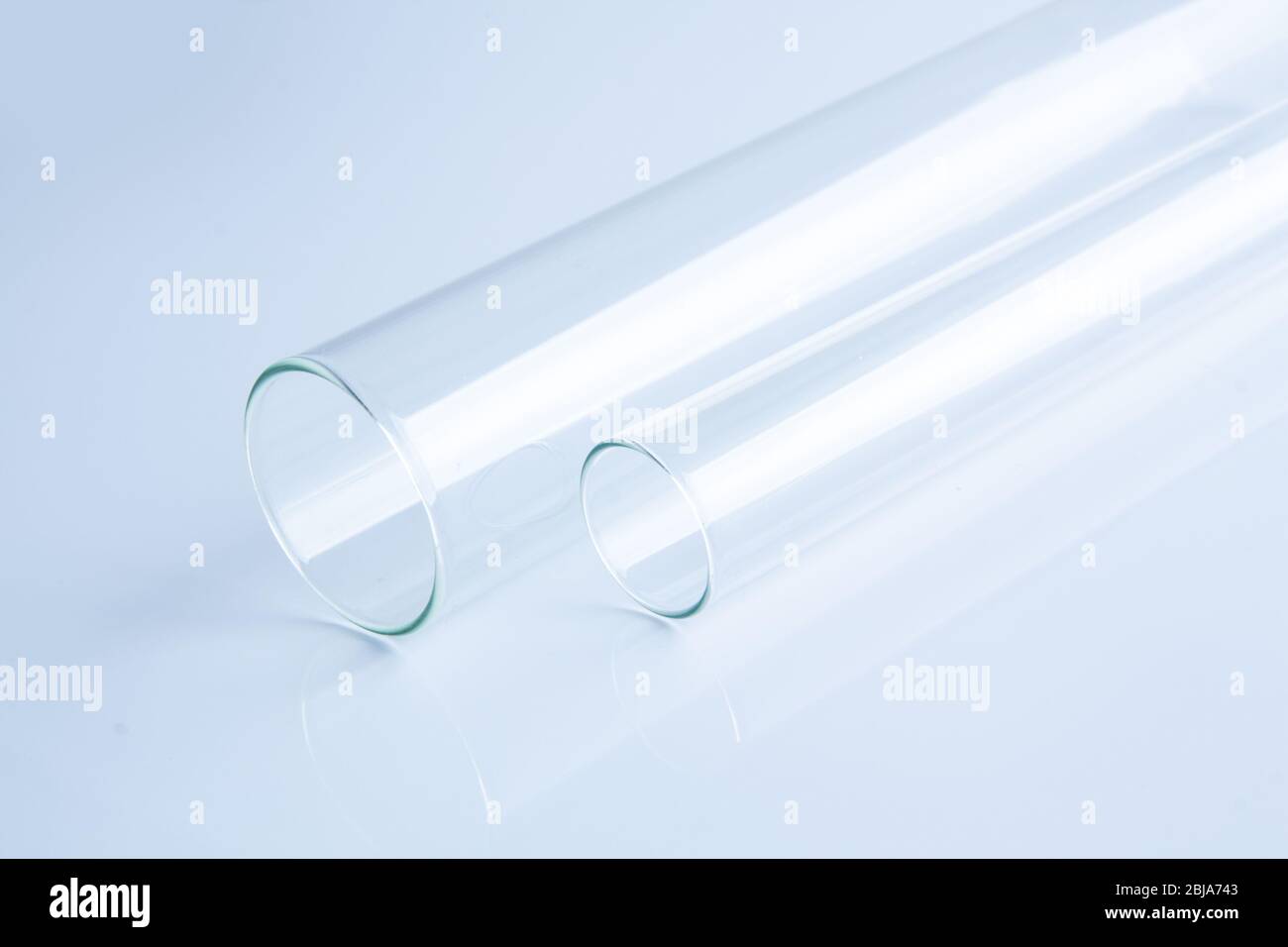 Science pipette with a pour of substance over laboratory test tubes ...