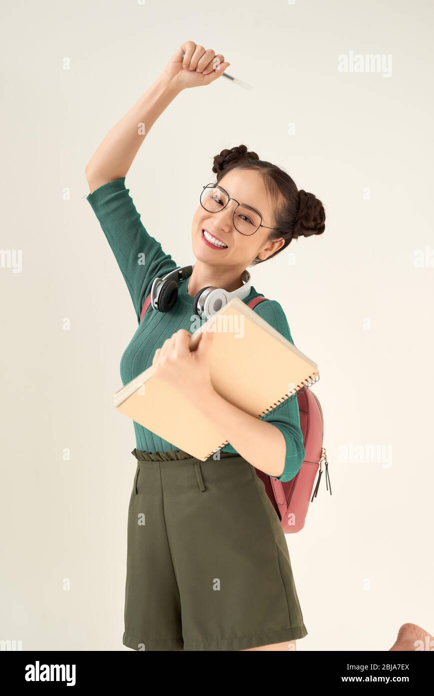 Beautiful student girl wearing backpack holding notebook over isolated ...