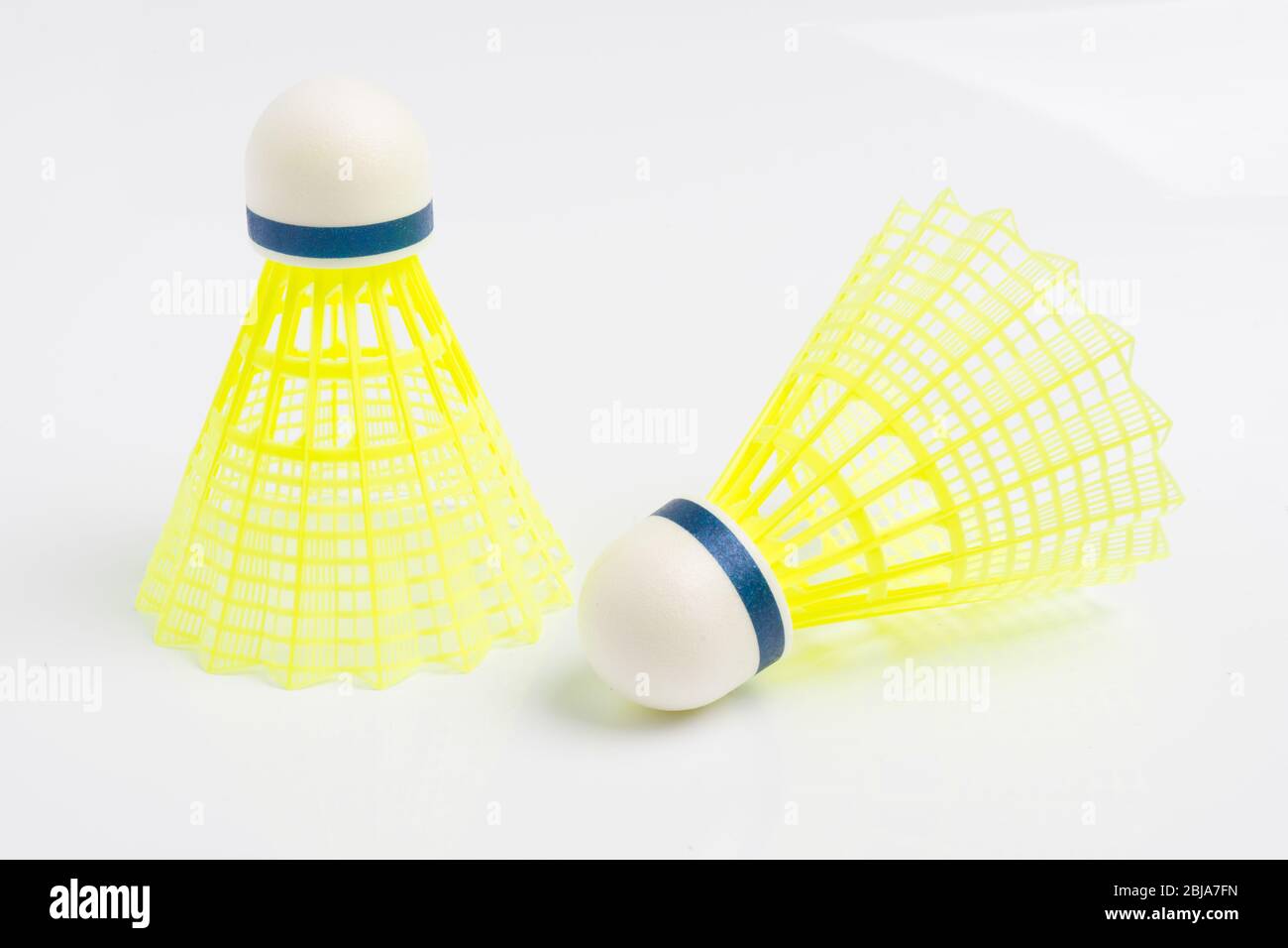 Yellow shuttlecock on white background Stock Photo - Alamy