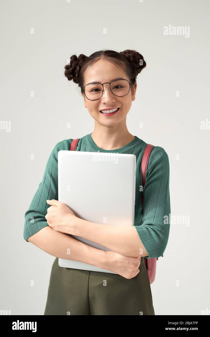 Happy young positive student walking to school holding laptop computer ...