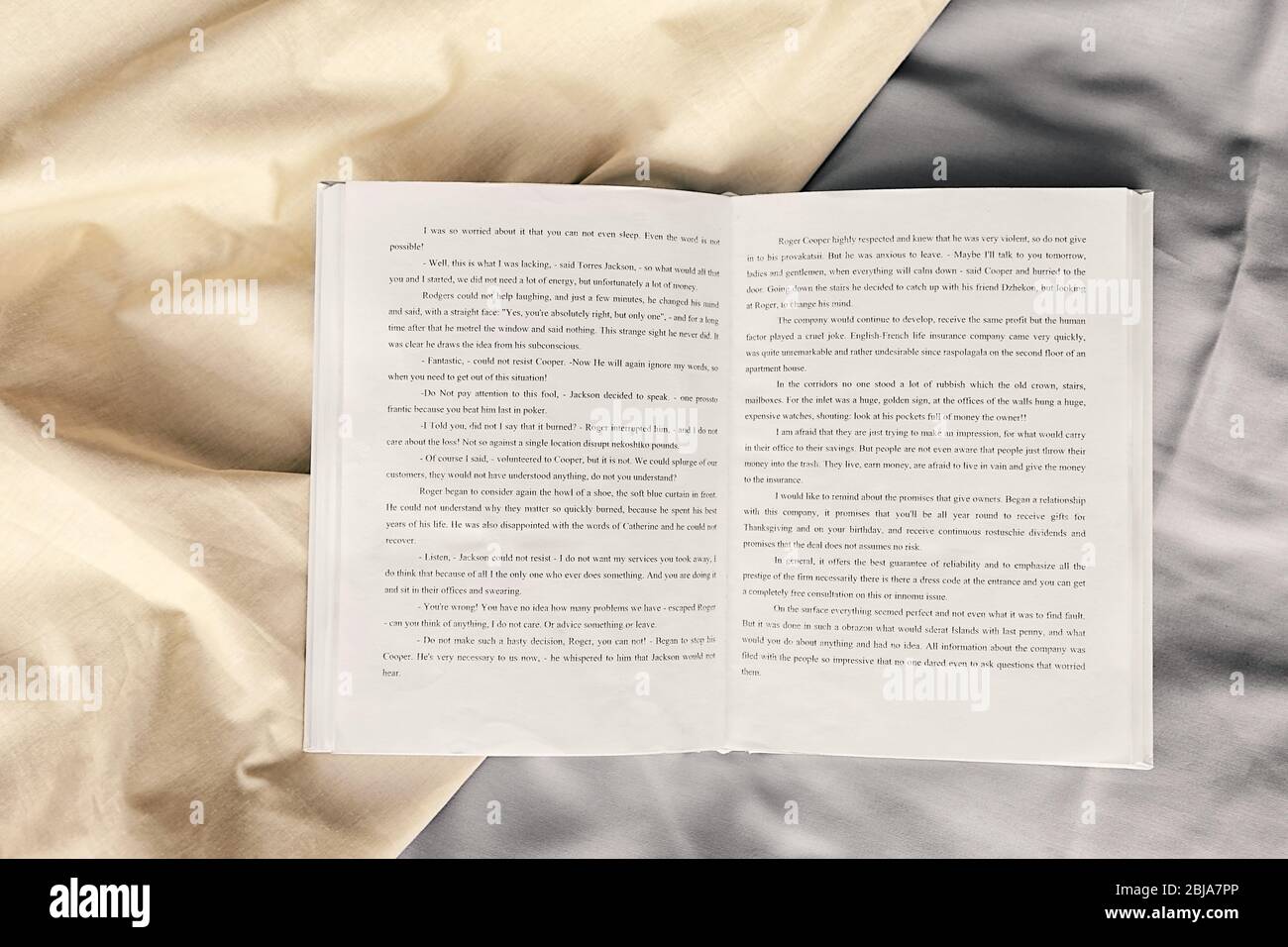 Opened book on crumpled sheet Stock Photo - Alamy