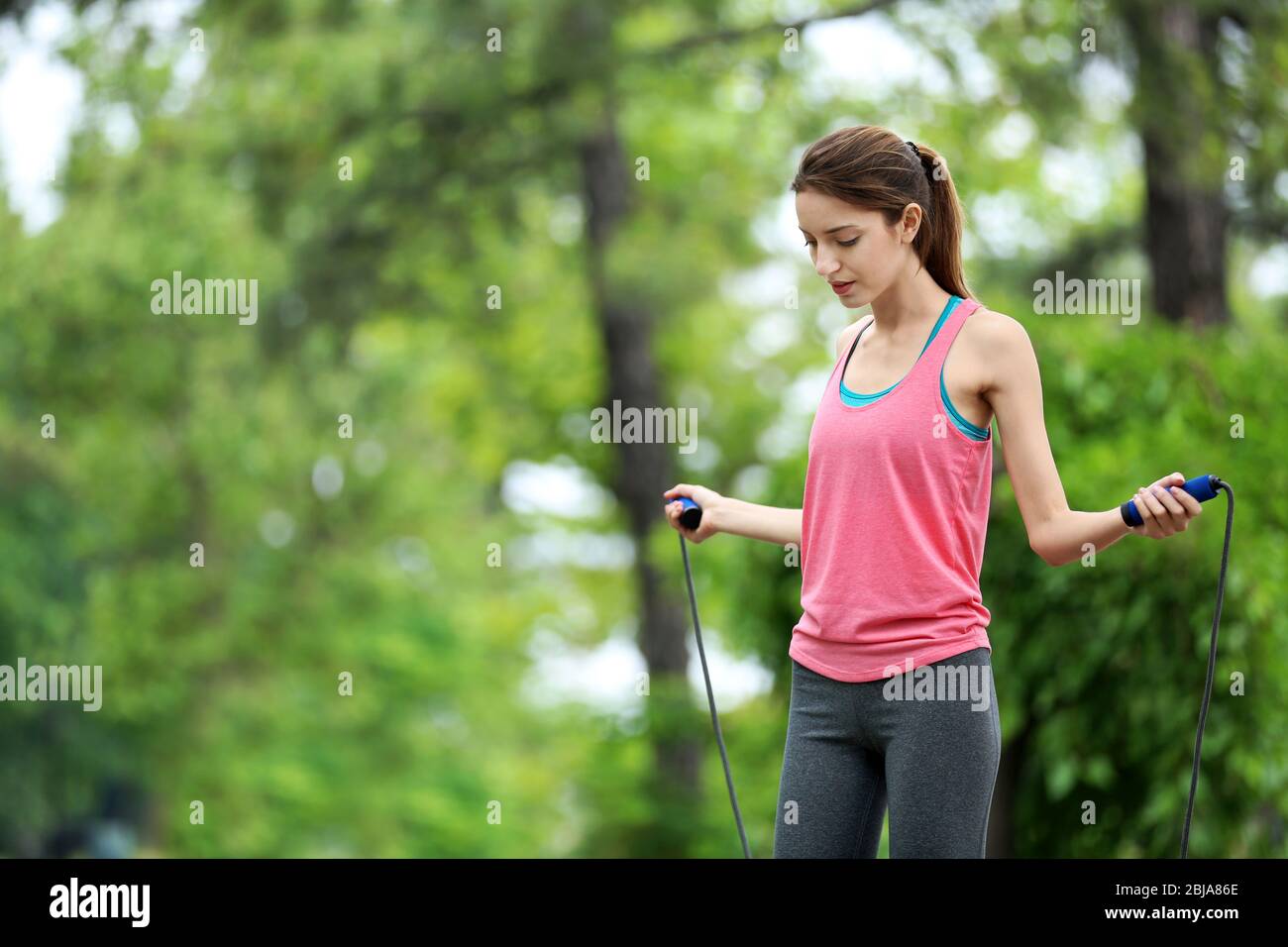 Young woman doing jump rope hi-res stock photography and images - Alamy