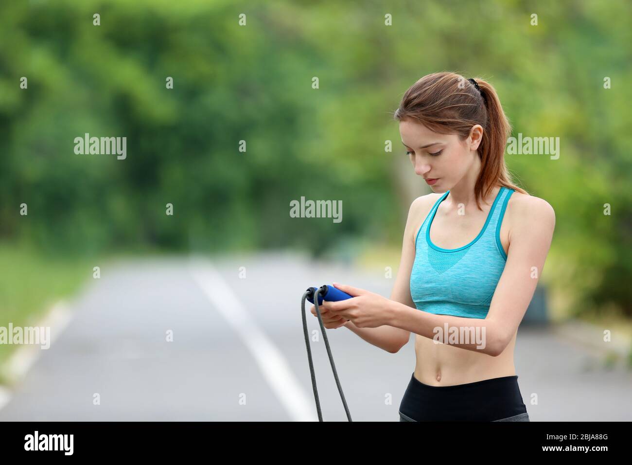 Young woman doing jump rope hi-res stock photography and images - Alamy