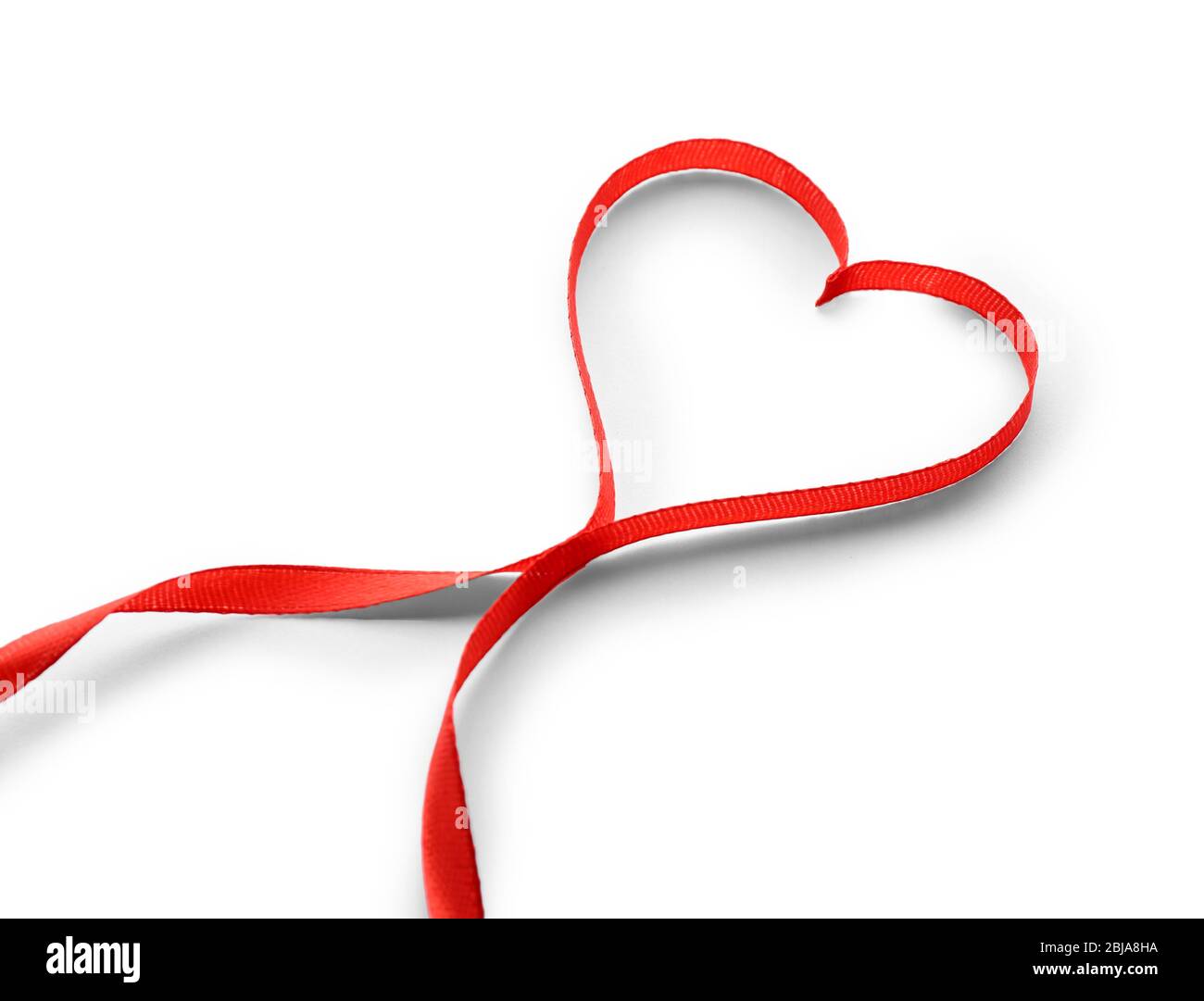 Red ribbon in shape of heart isolated on white Stock Photo - Alamy