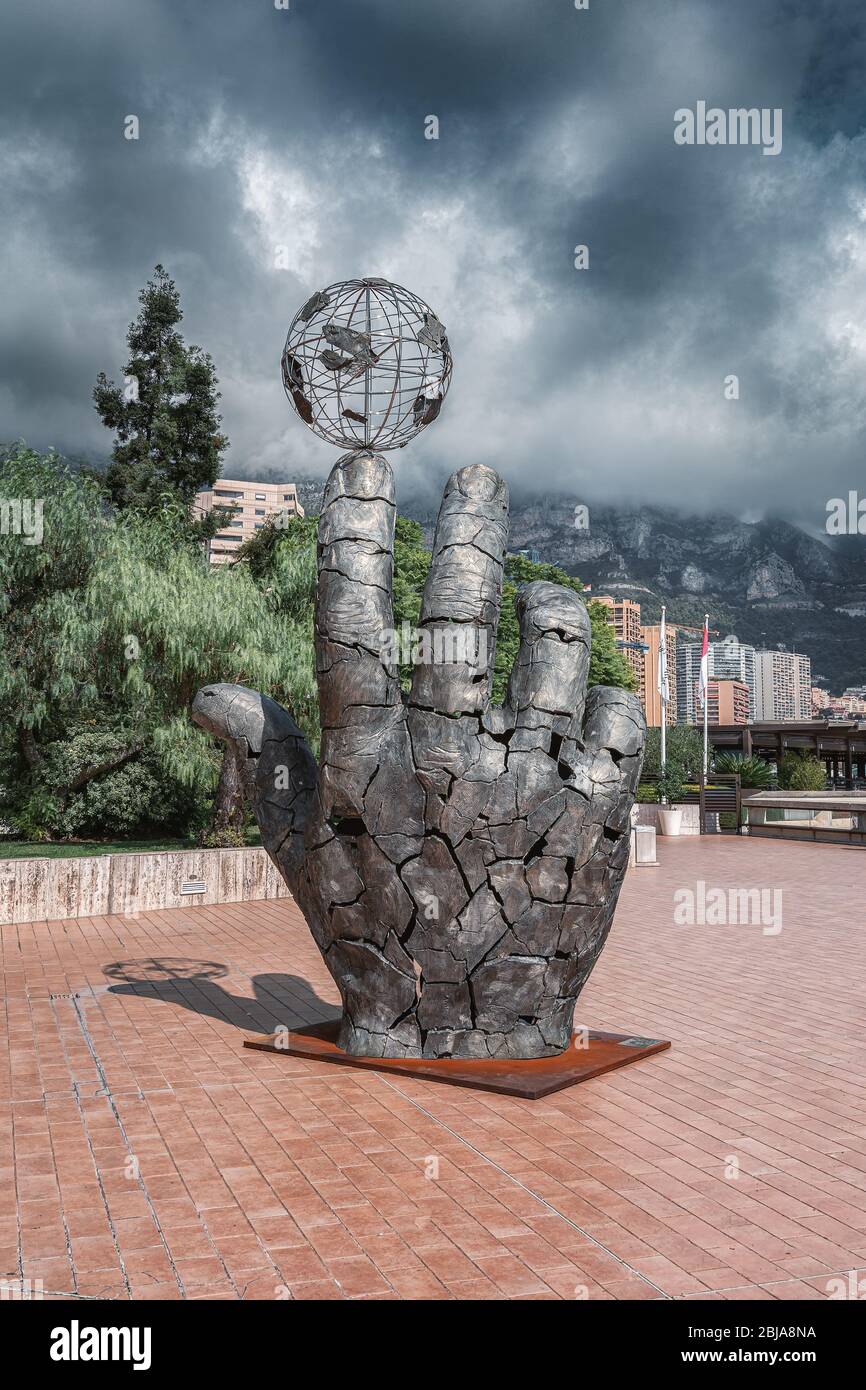 Scenic monaco hand balancing a globe statue hi-res stock photography ...