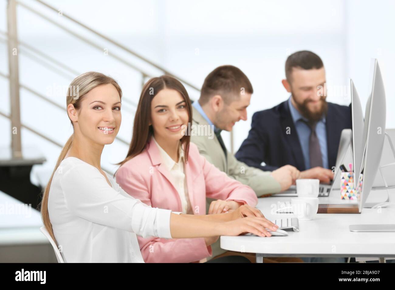 People working on computers at a office Stock Photo - Alamy