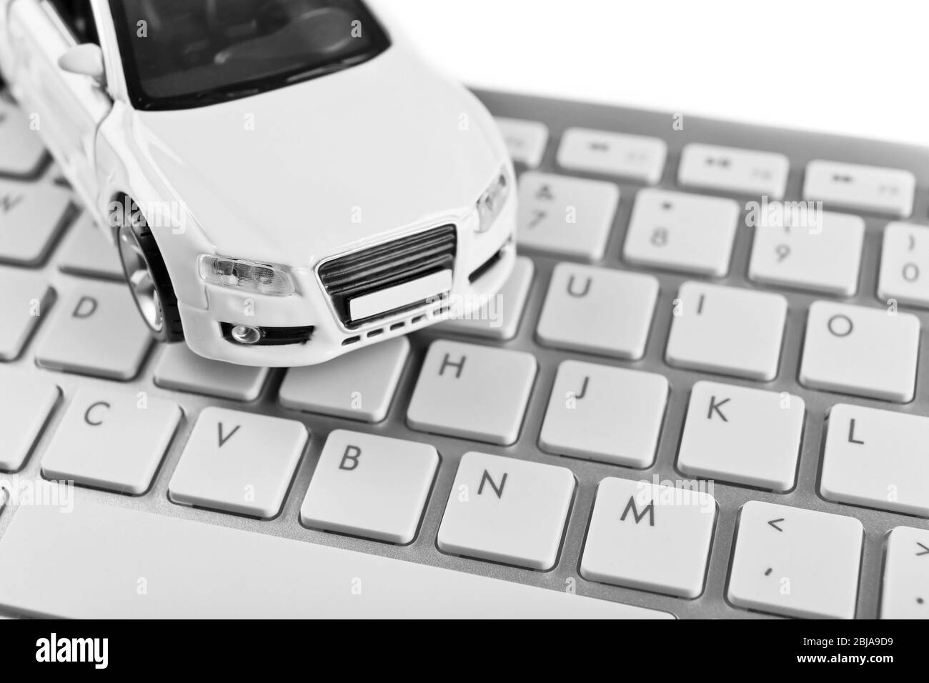 White toy car on a keyboard Stock Photo - Alamy