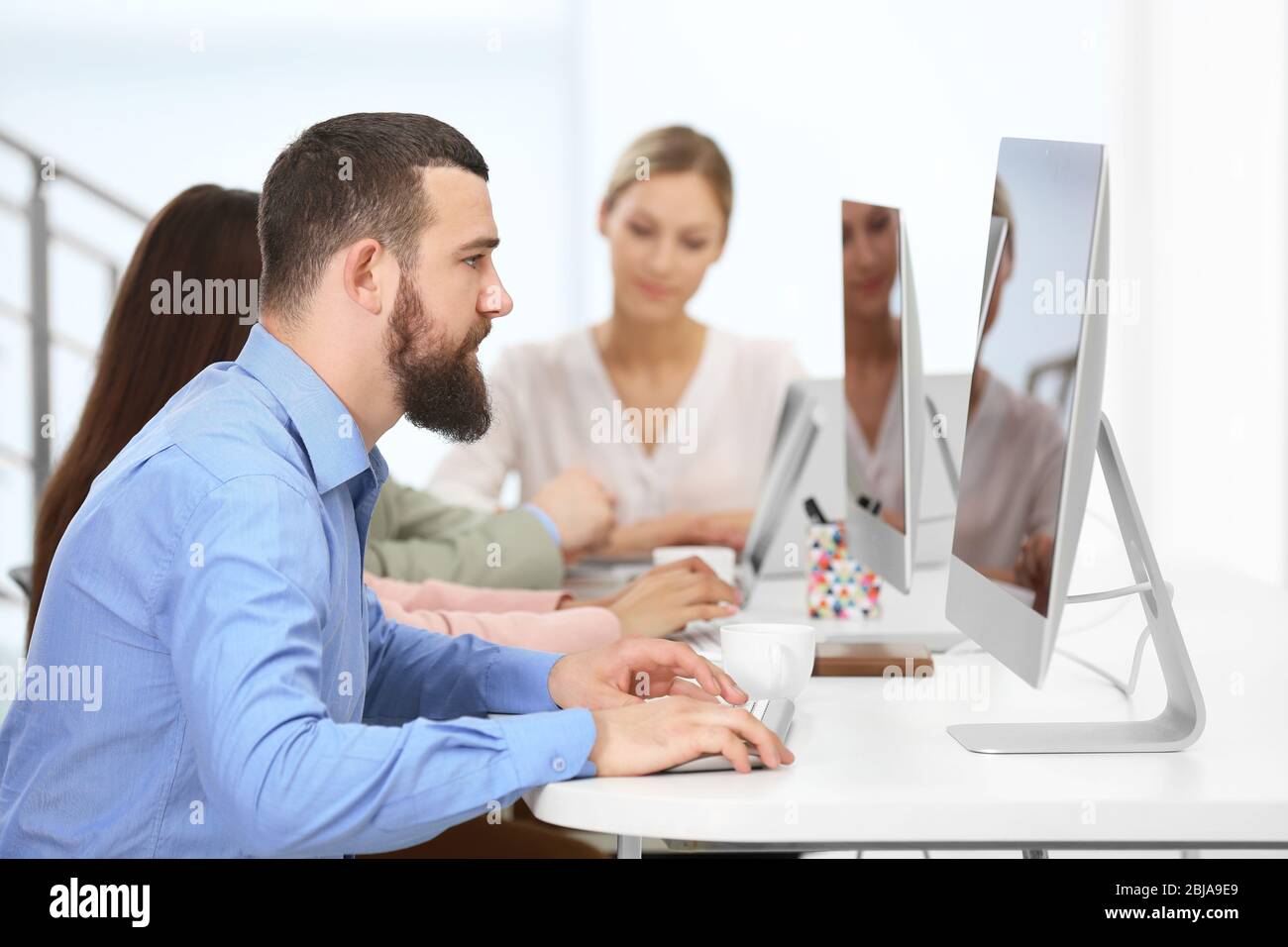 People working on computers at a office Stock Photo - Alamy