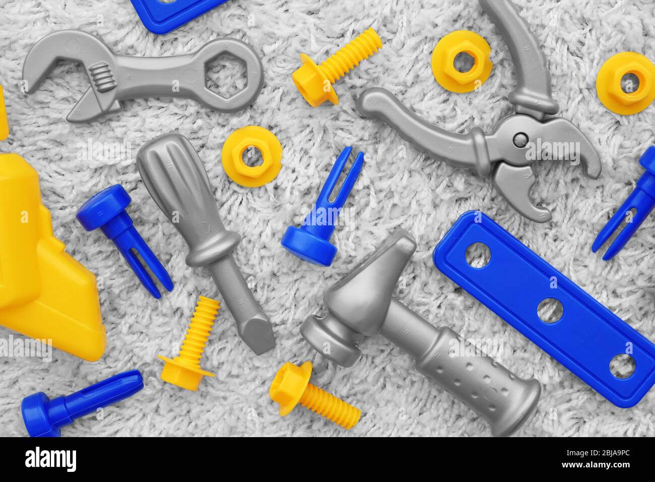 Set of plastic toy tools on a carpet Stock Photo - Alamy