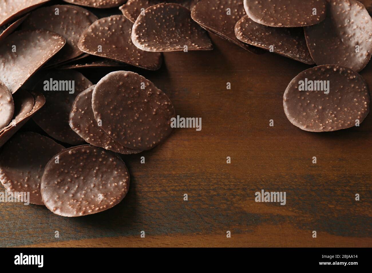 Chocolate crisps on wooden background Stock Photo - Alamy