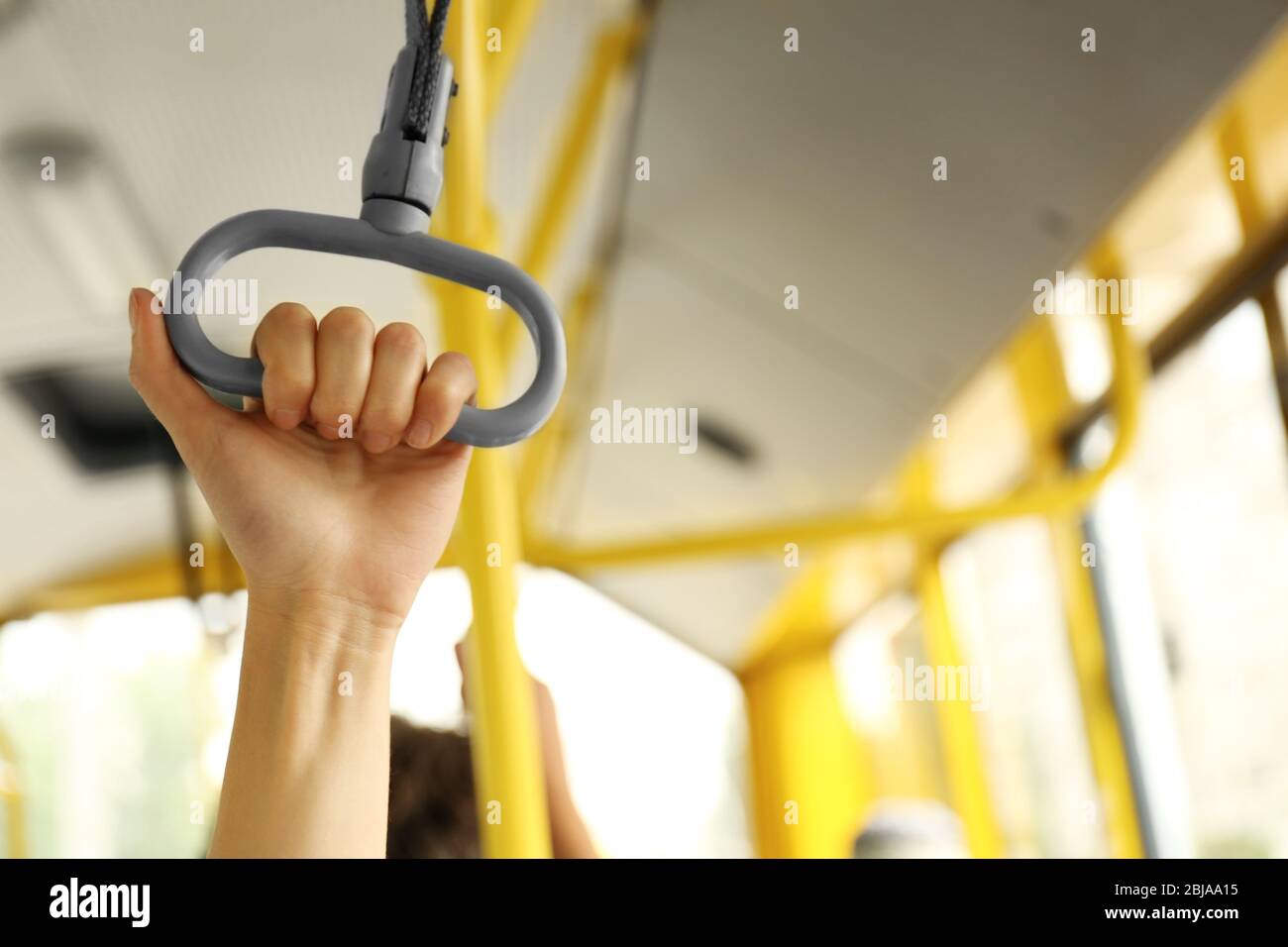 Hand holding handle on the public transport Stock Photo - Alamy