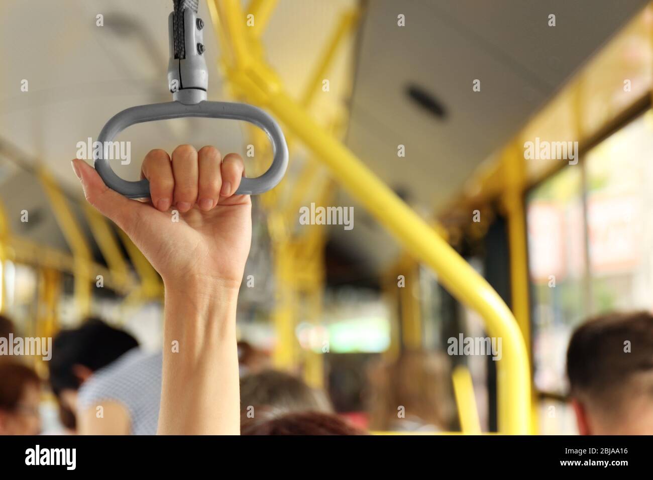 Hand holding handle on the public transport Stock Photo - Alamy