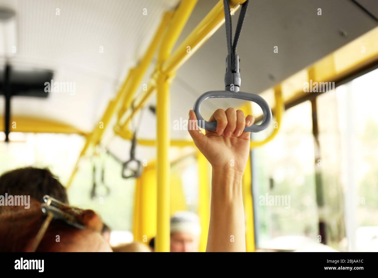 Hand holding handle on the public transport Stock Photo - Alamy