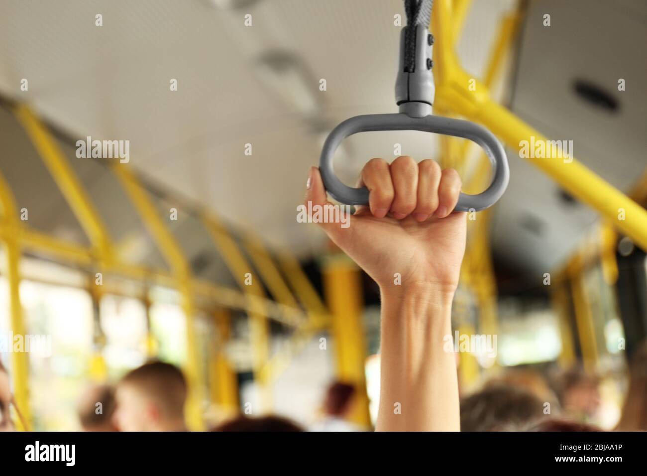 Hand holding handle on the public transport Stock Photo - Alamy