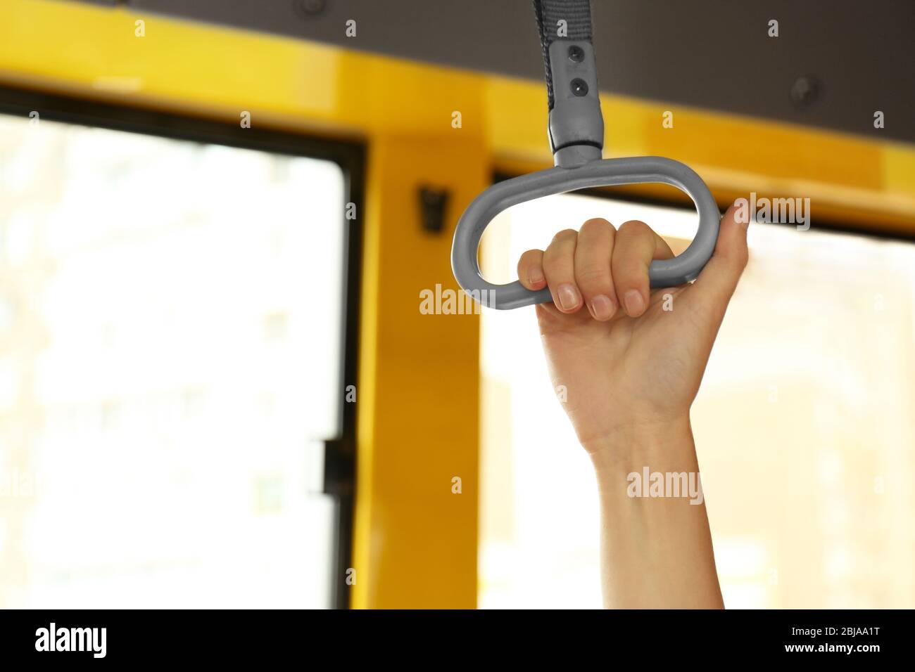 Hand holding handle on the public transport Stock Photo - Alamy
