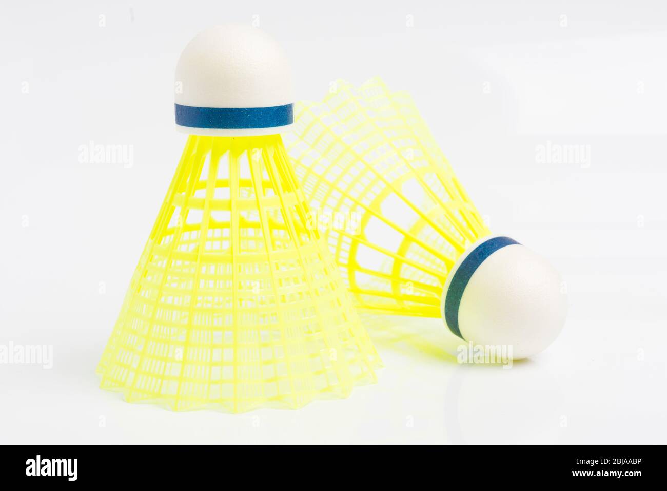Yellow shuttlecock on white background Stock Photo - Alamy