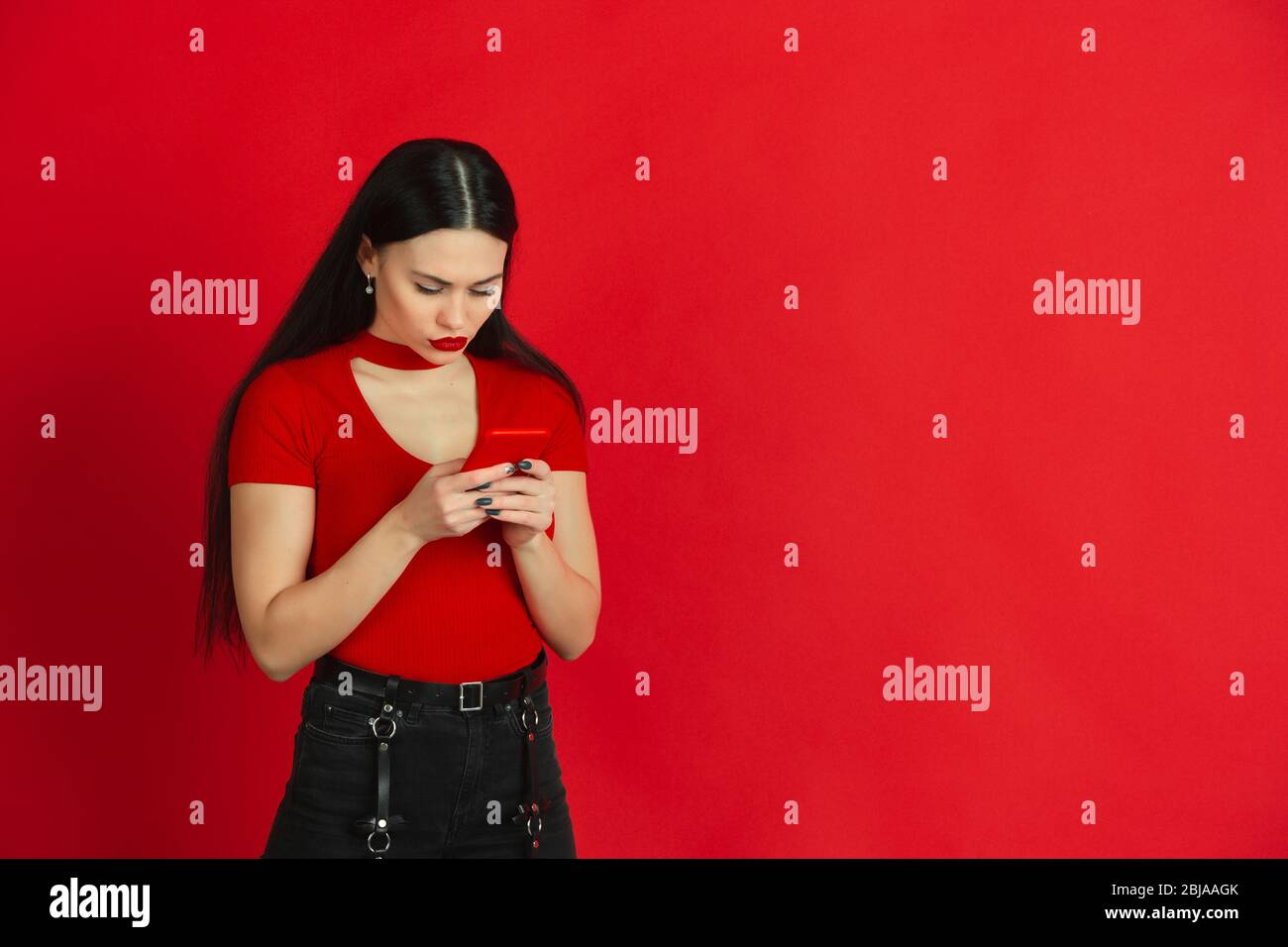 Scrolling smartphone. Caucasian young woman's monochrome portrait ...