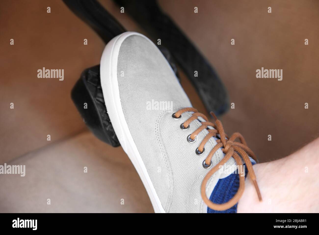 Foot pressing pedal of car Stock Photo - Alamy