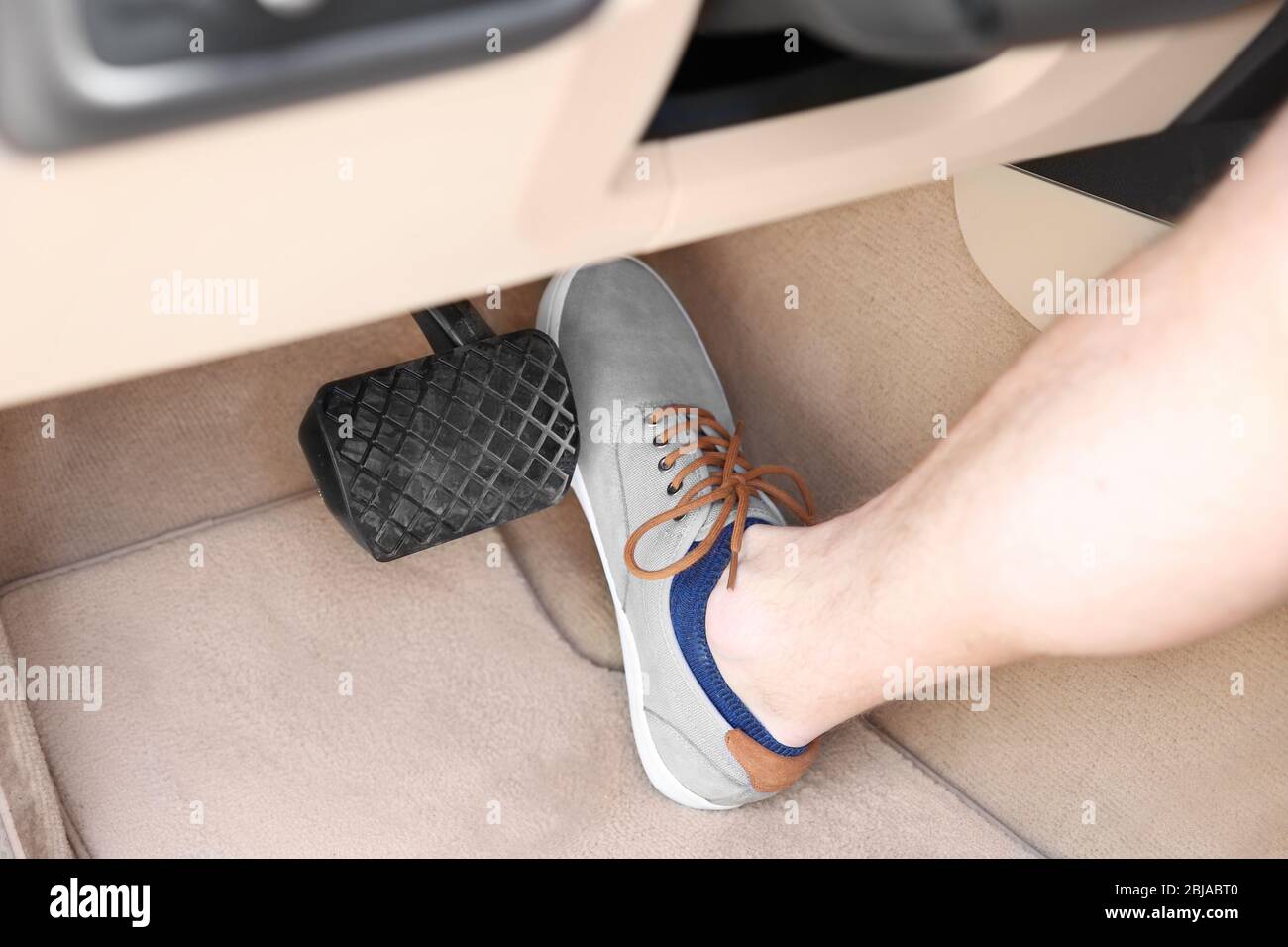 Foot pressing pedal of car Stock Photo - Alamy