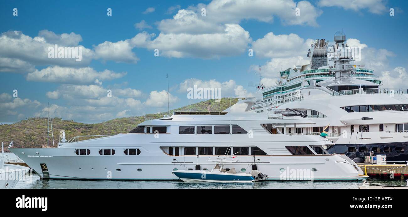Small Boat by Yacht by Cruise Ship Stock Photo - Alamy