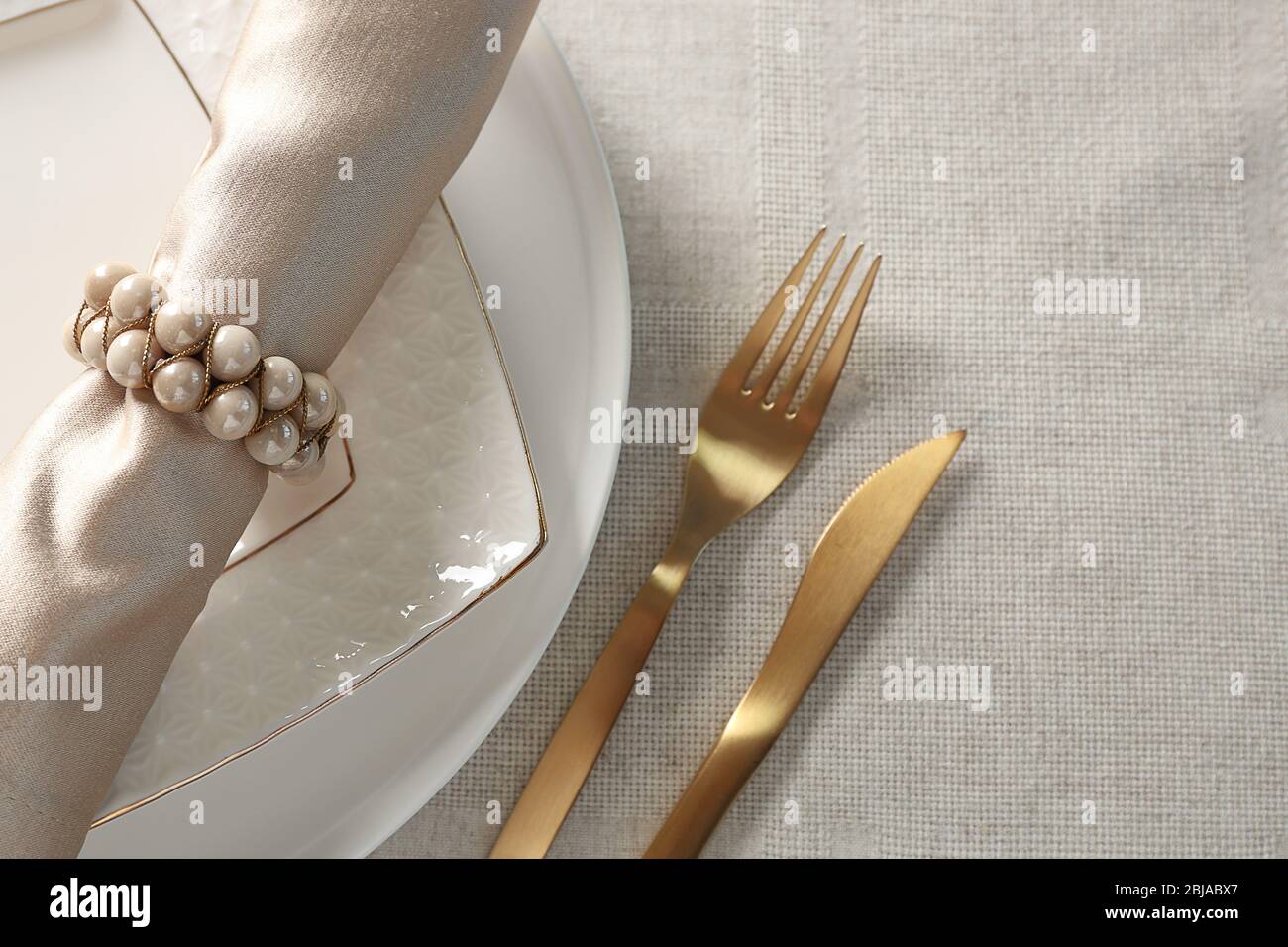 Beautiful table setting on light textile background Stock Photo - Alamy