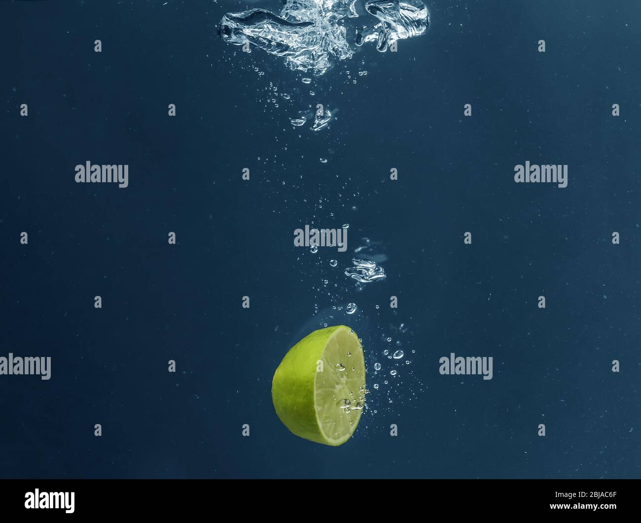 Sliced lime lemon falling water hi-res stock photography and images - Alamy