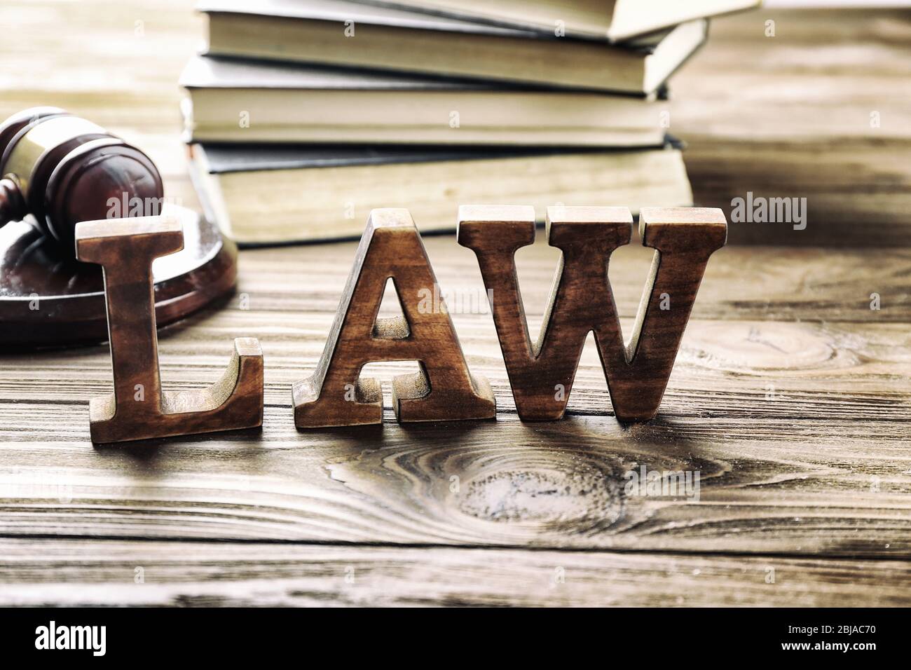 Word law with judges gavel and legal books on wooden background Stock ...