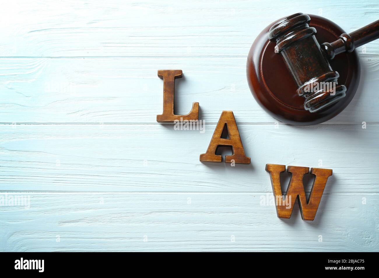 Word law with judges gavel on wooden background Stock Photo - Alamy