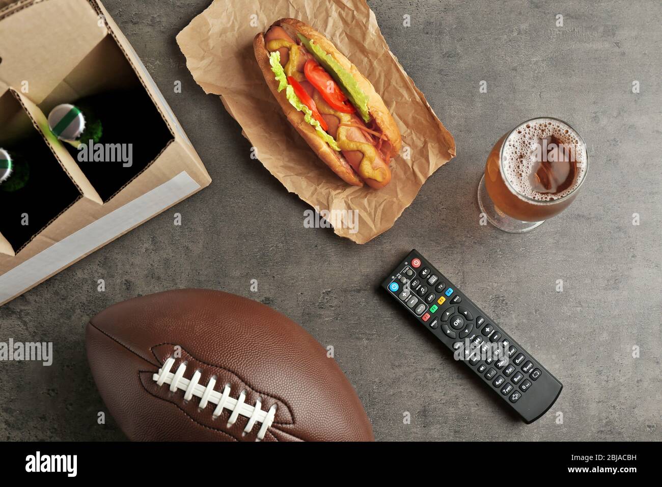TV remote control, beer and ball on gray background Stock Photo - Alamy