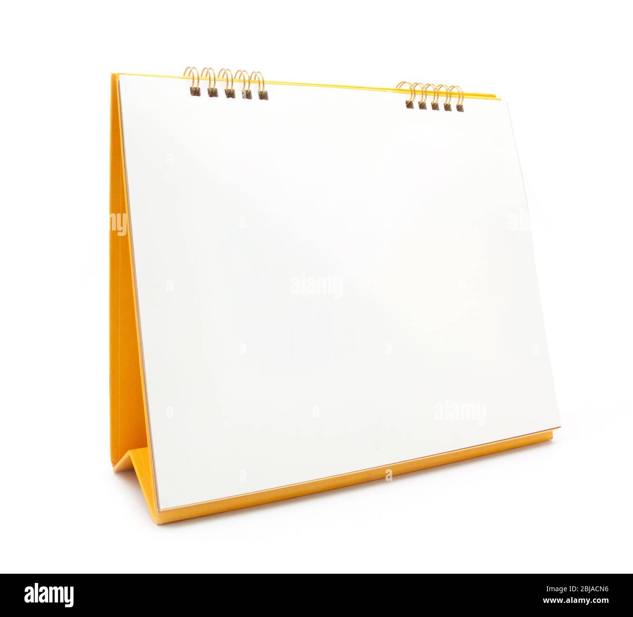 Yellow desk calendar isolated on white background Stock Photo - Alamy