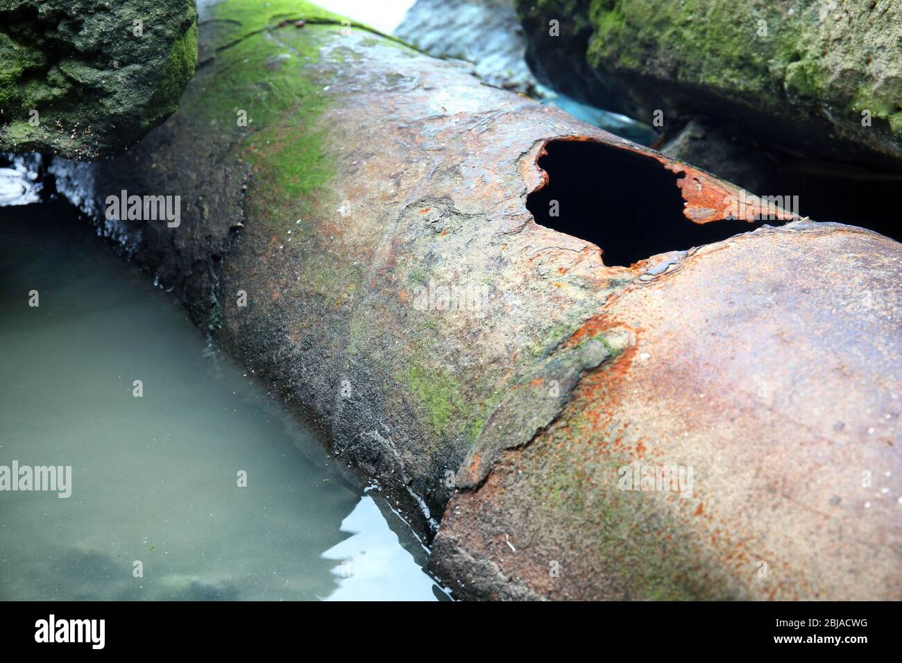 Rusty pipe in polluted water Stock Photo - Alamy