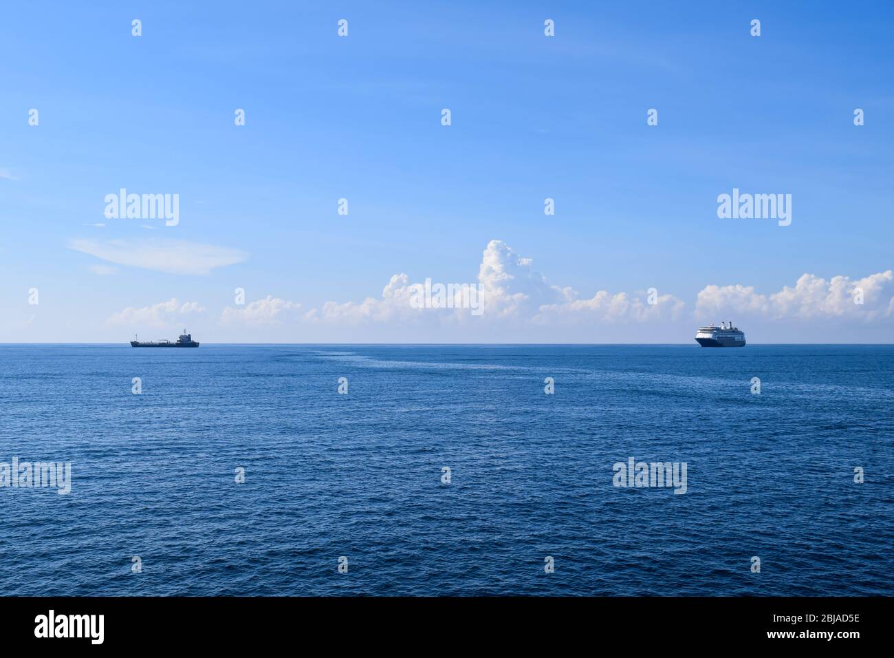 cruise ship and a boat in ocean Stock Photo - Alamy