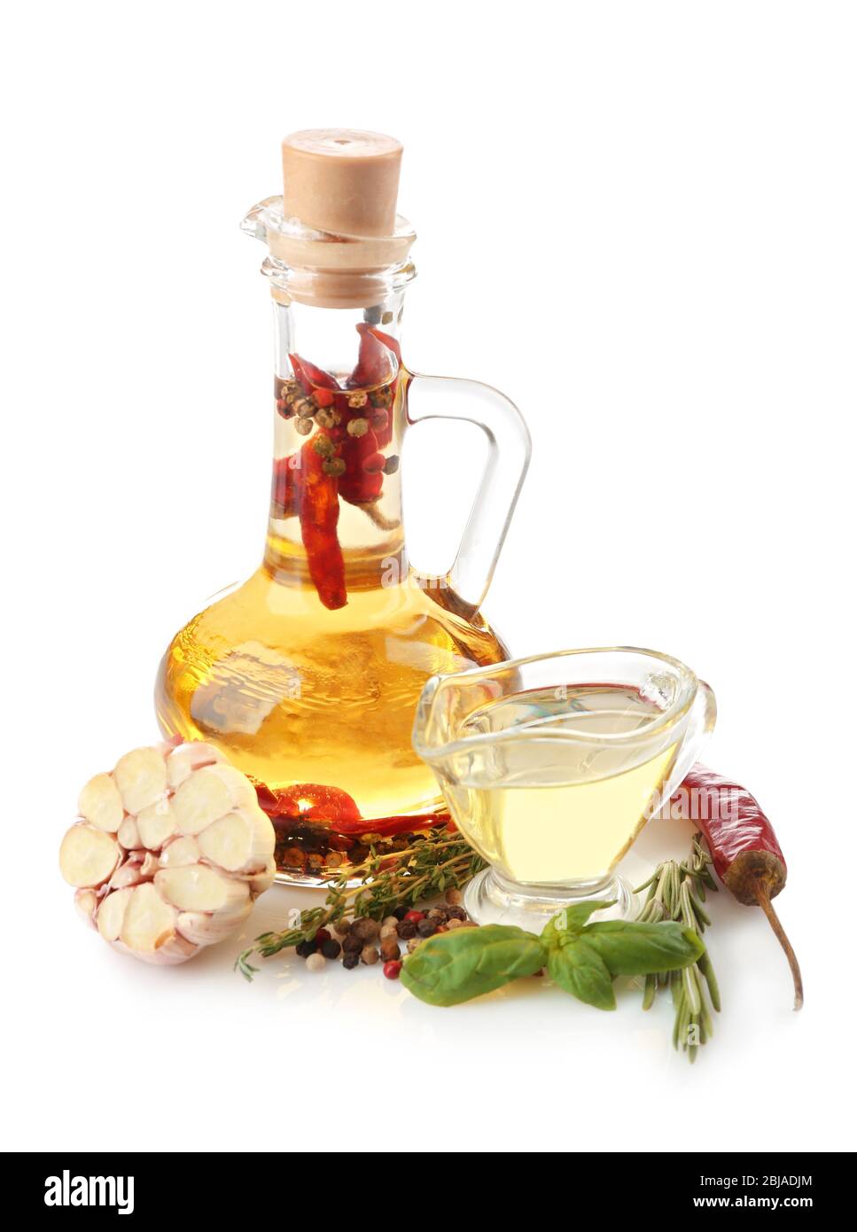 Olive oil with spices, isolated on white Stock Photo - Alamy