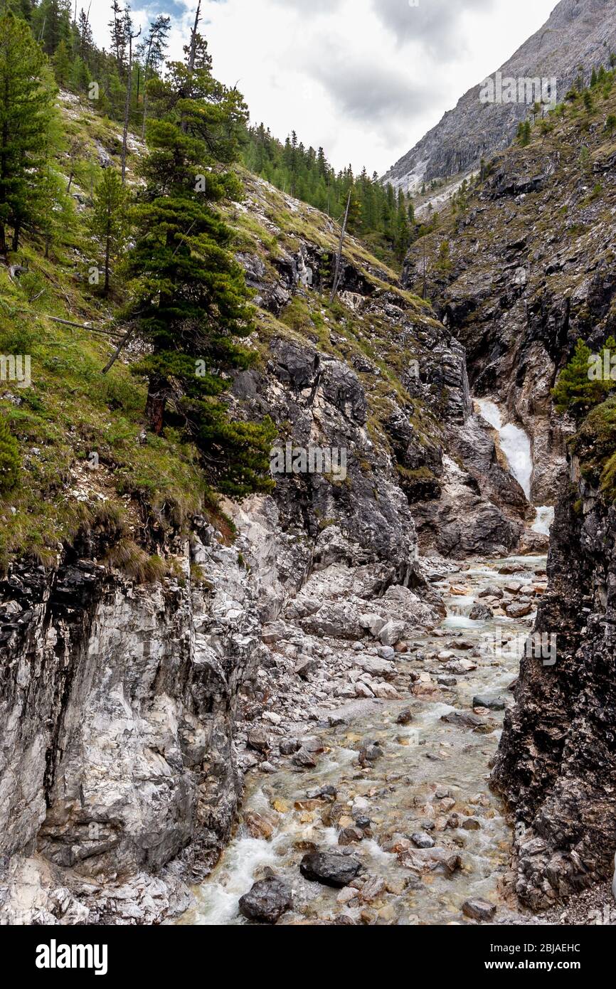 Gorge with a river in the mountains. A small waterfall at the end ...