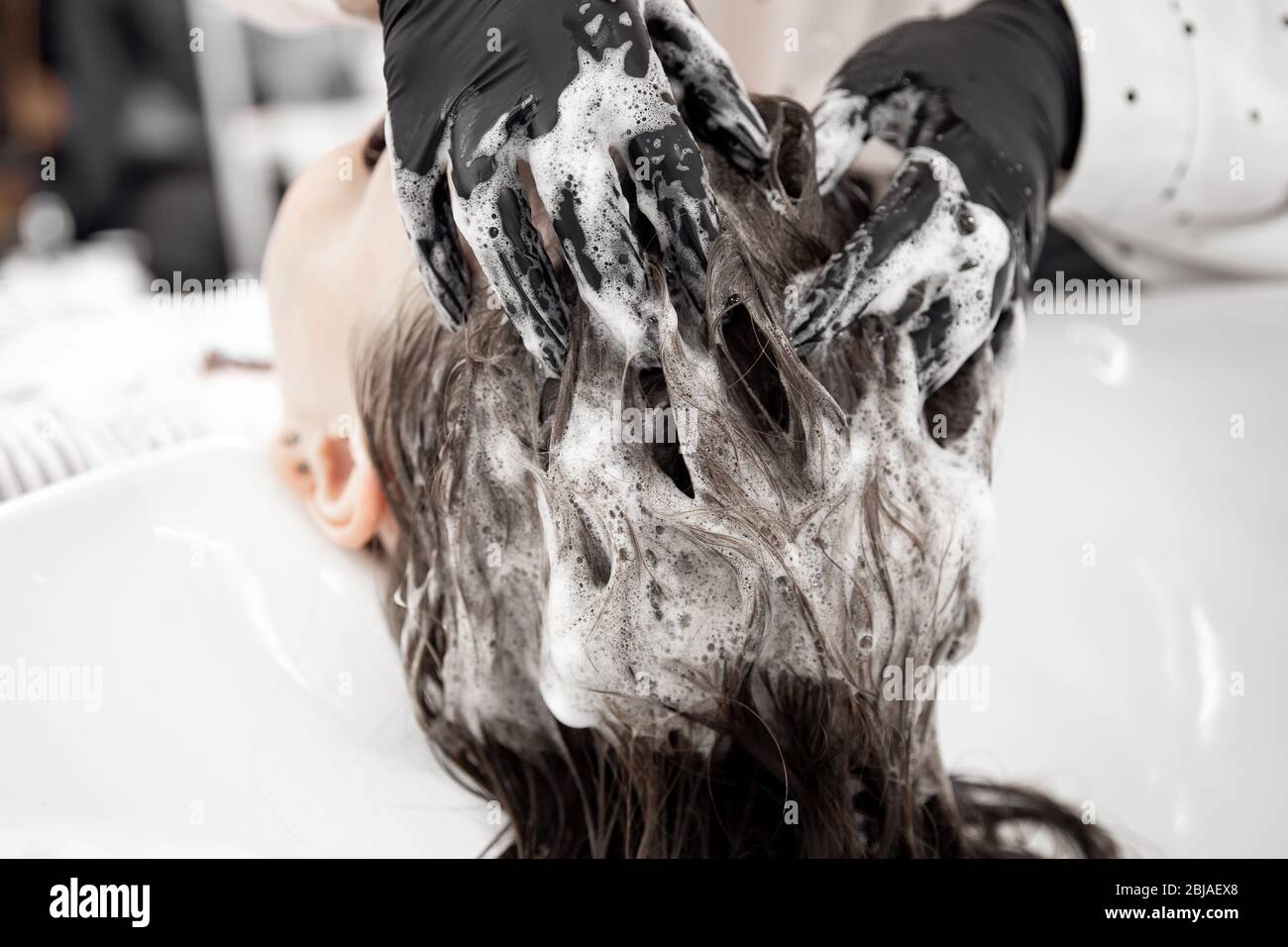 Wash procedure in sink. Care of scalp, hair structure against loss and ...