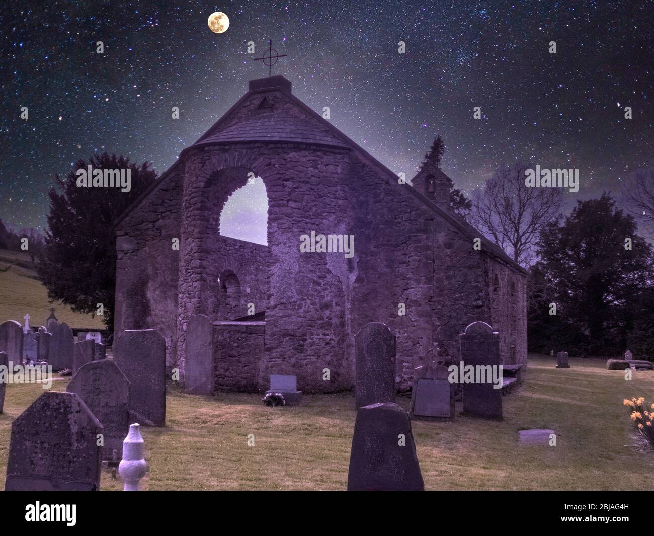 The ghostly ruin of a medieval church at night with starry sky and the ...