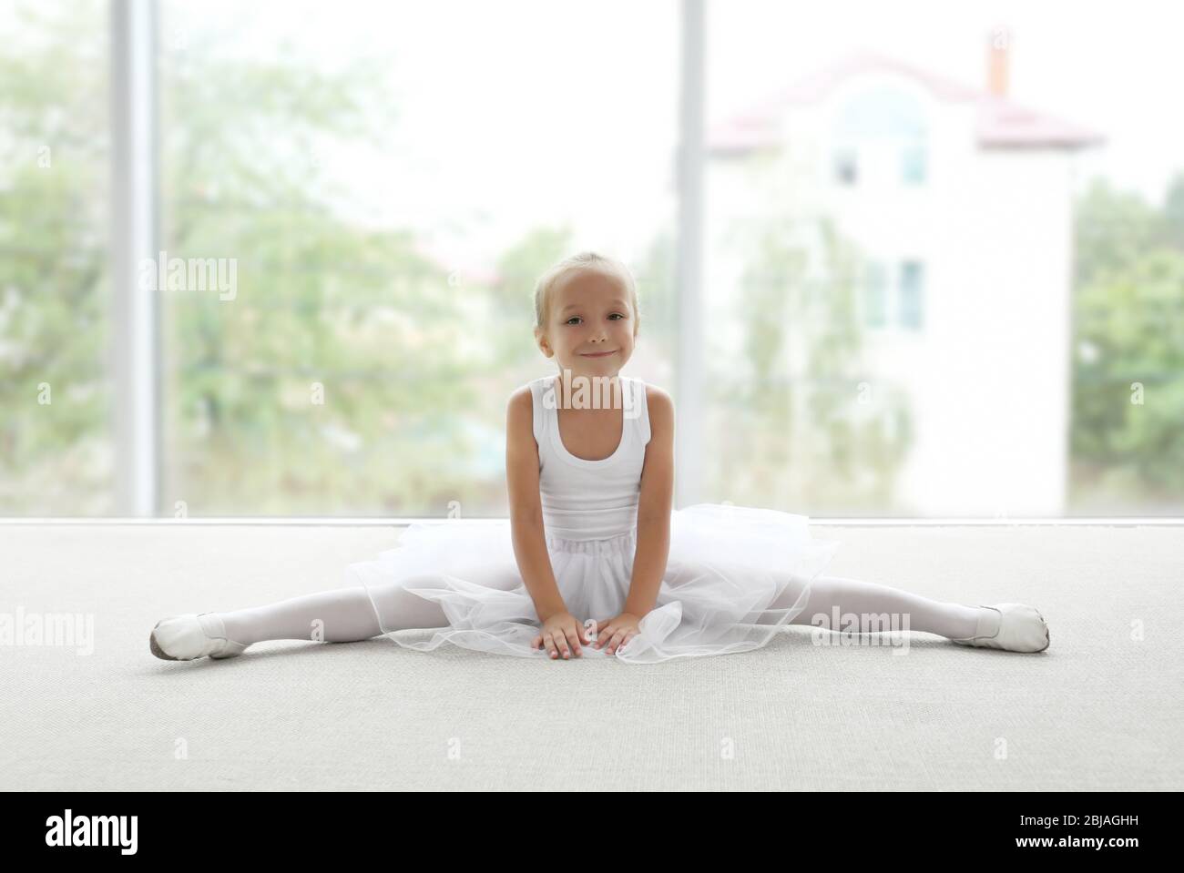 Cute ballerina sitting on the floor at ballet class Stock Photo - Alamy