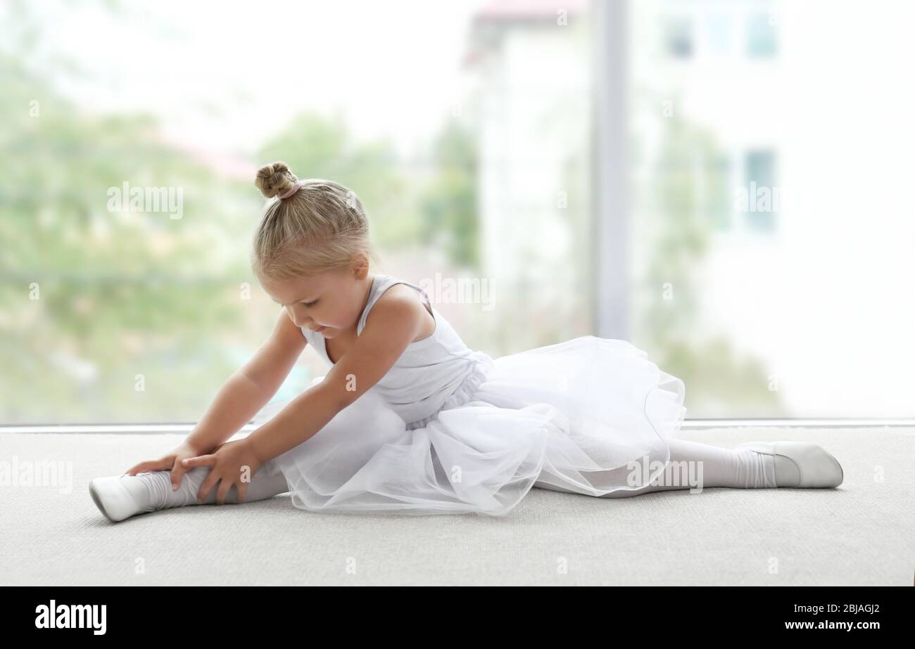 Cute ballerina sitting on the floor at ballet class Stock Photo - Alamy