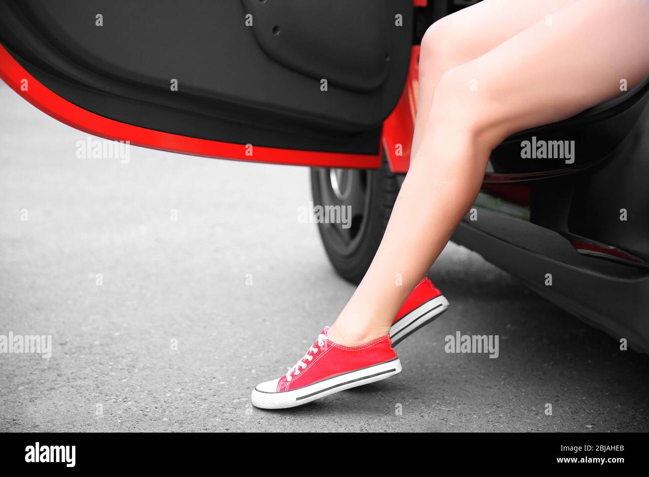 Woman out of car Stock Photo - Alamy