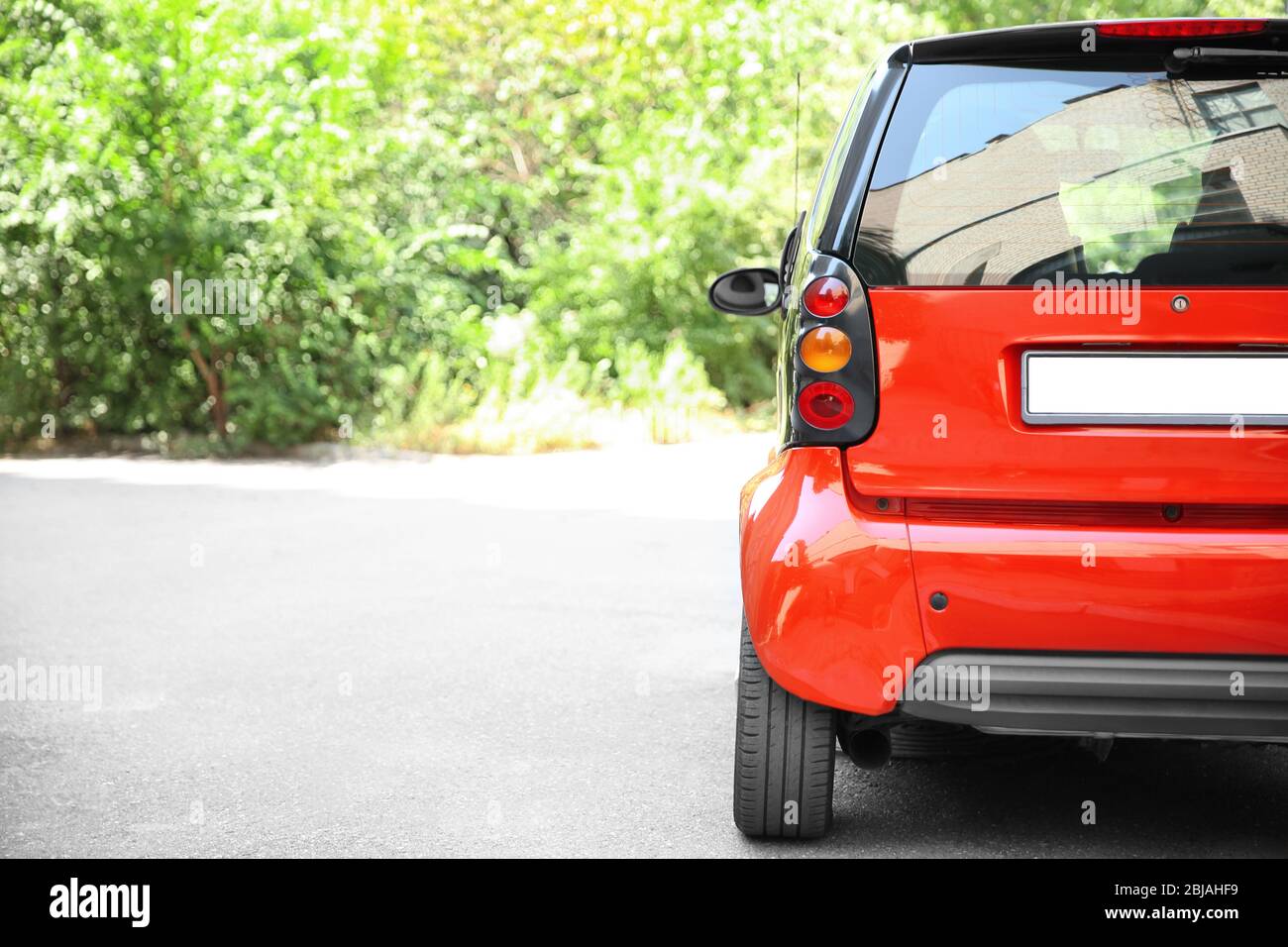 Red car on street Stock Photo - Alamy