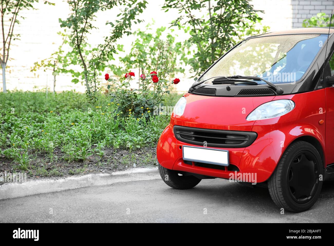 Red car on street Stock Photo - Alamy