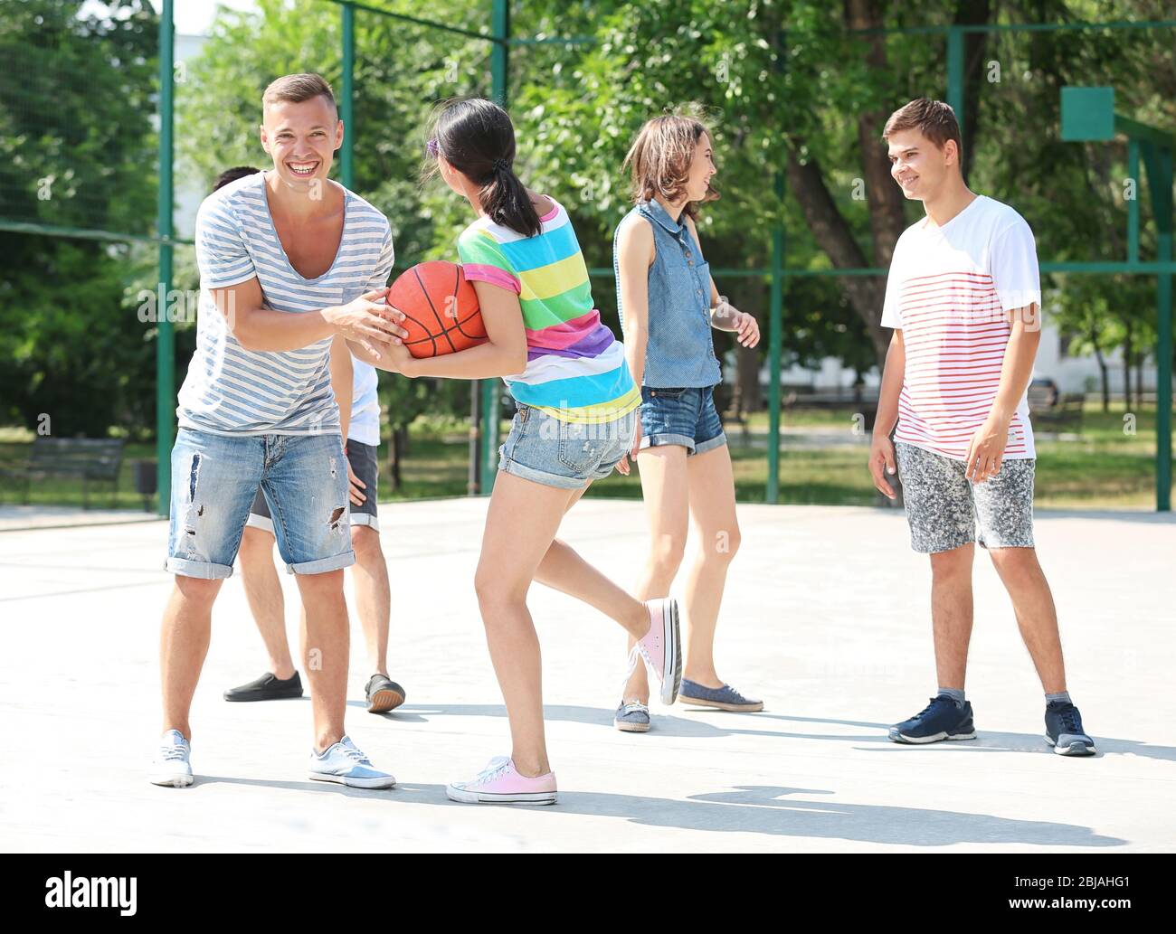 Group happy teenagers playing basketball hi-res stock photography and ...