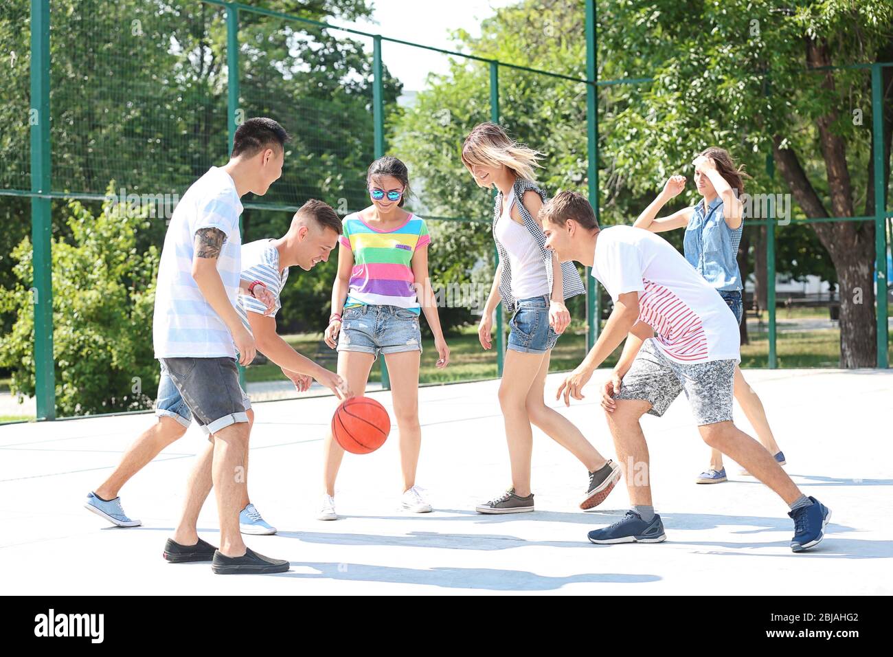 Teenagers playing basketball Stock Photo - Alamy