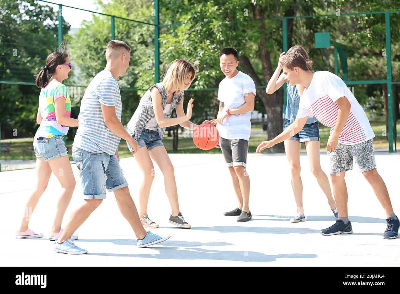 Teenagers playing basketball Stock Photo - Alamy