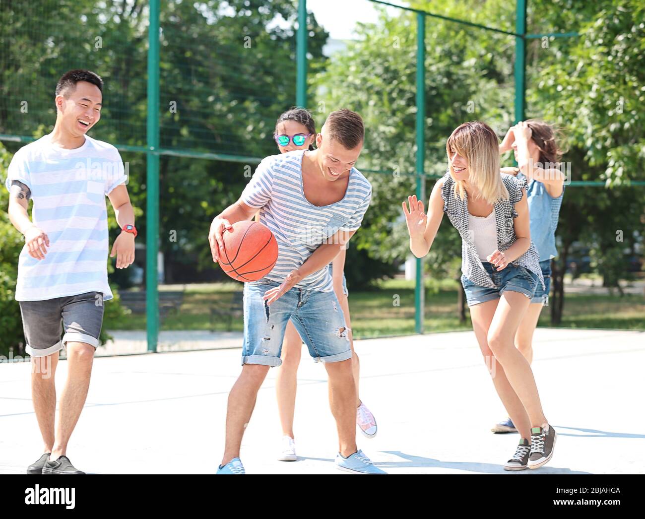 Teenagers playing basketball Stock Photo - Alamy