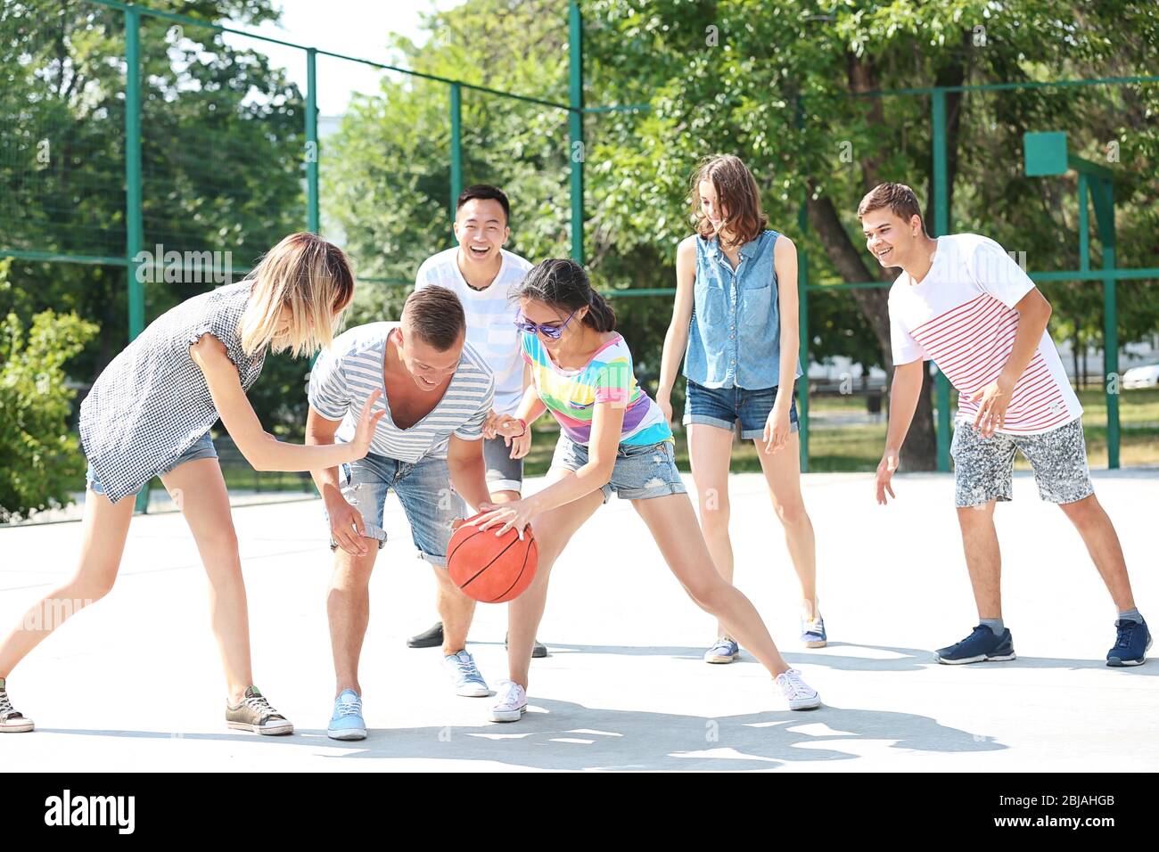 Teenagers playing basketball Stock Photo - Alamy