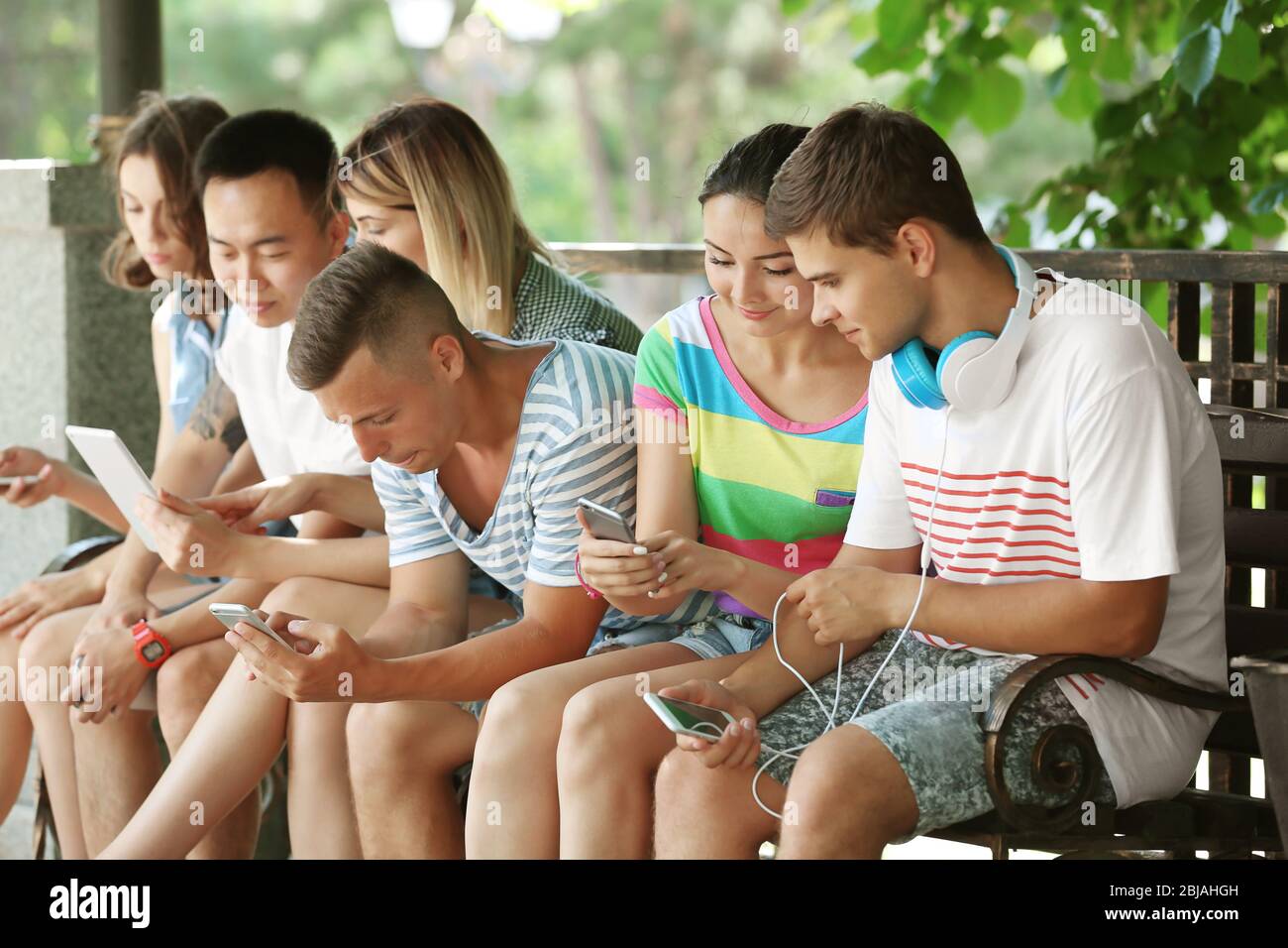 Teenagers with gadgets on street Stock Photo - Alamy