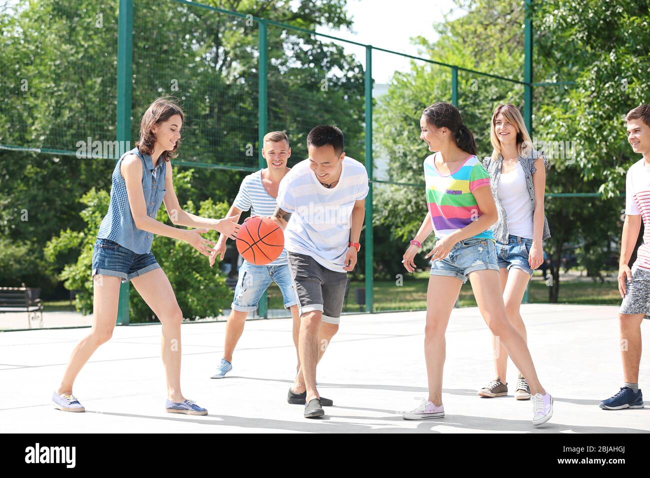 Teenagers playing basketball Stock Photo - Alamy