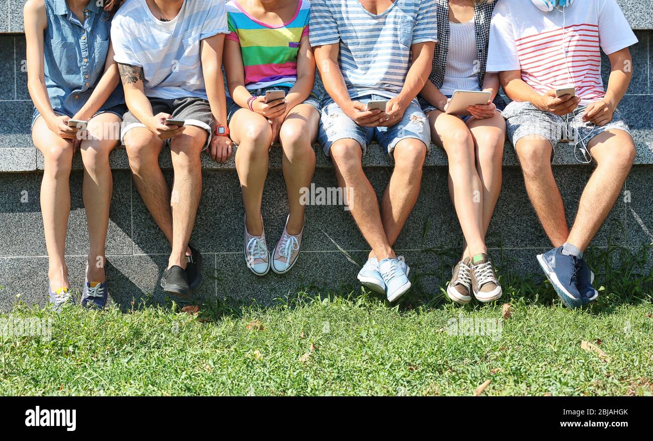 Teenagers with gadgets on street Stock Photo - Alamy
